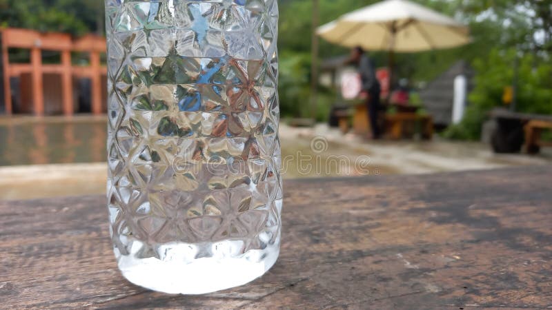A Bottle of Mineral Water on a Wet Wooden Table Stock Image - Image of ...