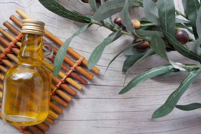 Bottle of Olive Oil and Olive Leaves on Yellow Stock Photo - Image of ...
