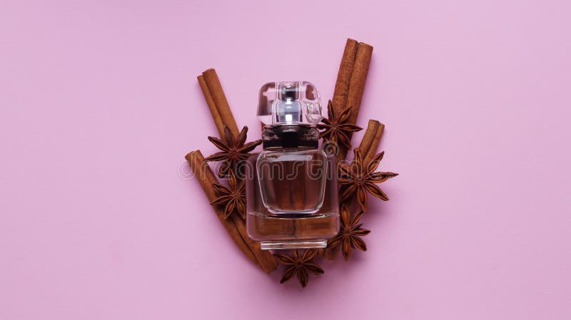 Bottle of Perfume, Cloves and Cinnamon Sticks on Pink Background, Top ...