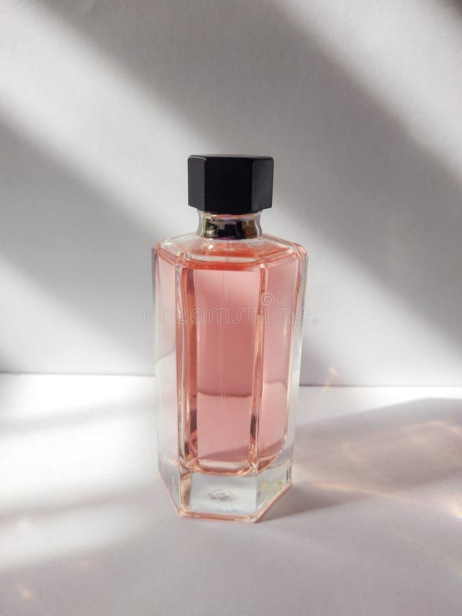 A Bottle of Perfume for Women in Peach Color Stock Photo - Image of ...