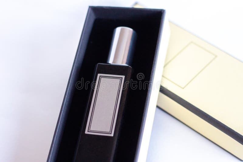 A Bottle of Perfume from a Yellow Box on a White Isolated Background ...