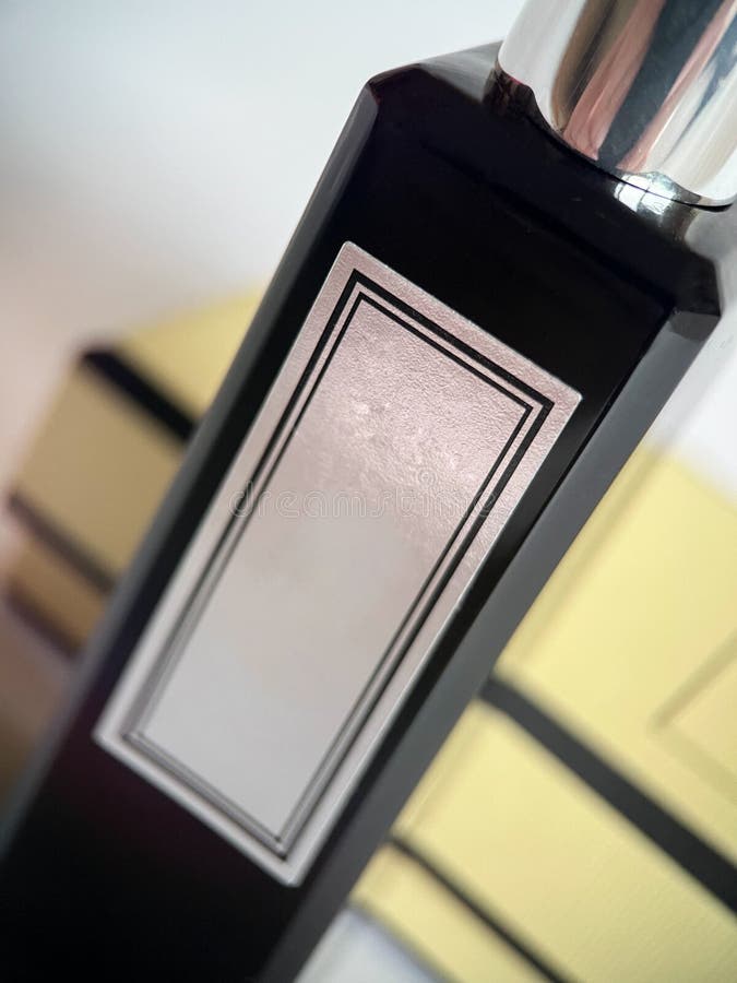 A Bottle of Perfume from a Yellow Box on a White Isolated Background ...