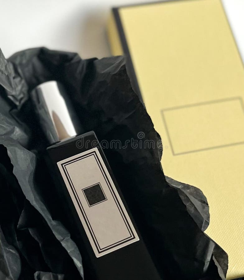 A Bottle of Perfume from a Yellow Box on a White Isolated Background ...