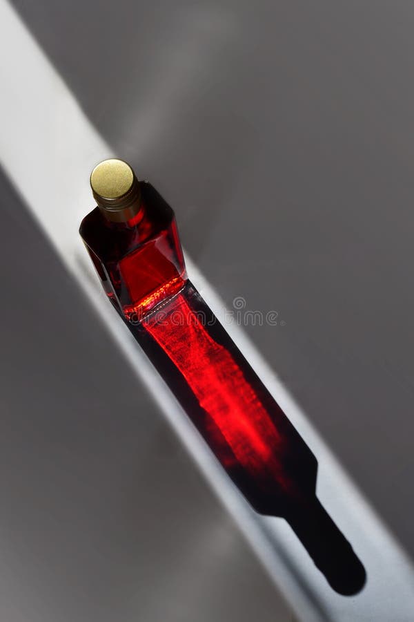 A Bottle of Pink Wine in a Beam of Light with a Big Shadow Stock Photo ...
