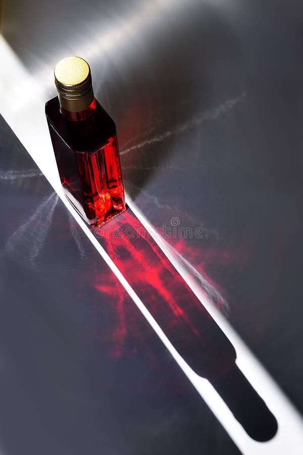A Bottle of Pink Wine in a Beam of Light with a Big Shadow Stock Photo ...