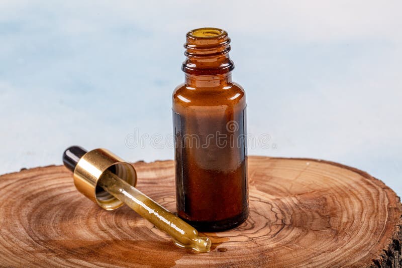 A Bottle of Propolis on Piece of Wood Propolis Drop Oil Drop Falling ...