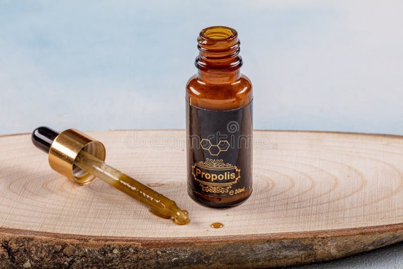 A Bottle of Propolis on Piece of Wood Propolis Drop Oil Drop Falling ...