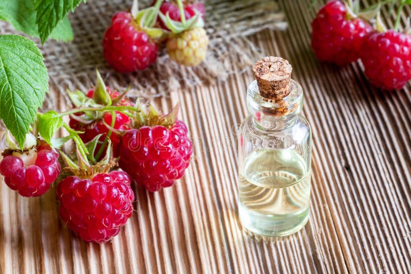 A Bottle of Raspberry Seed Oil with Fresh Raspberries Stock Photo ...