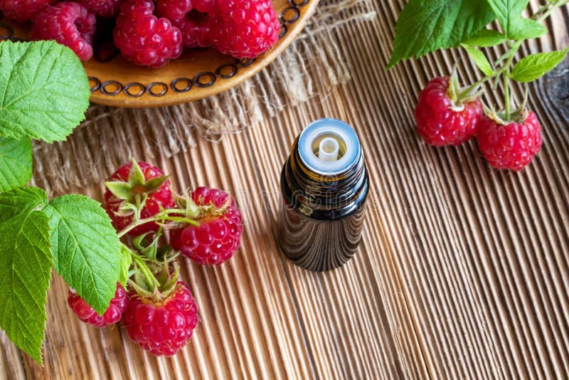 A Bottle of Raspberry Seed Oil with Fresh Raspberries Stock Image ...