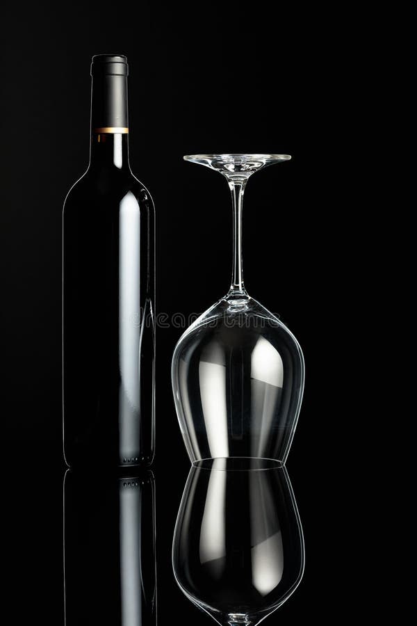 Bottle of Red Wine and an Inverted Wine Glass on a Black Background ...