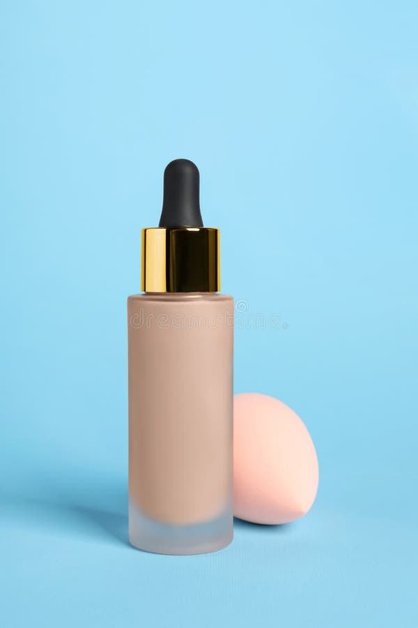 Bottle of Skin Foundation and Sponge on Light Blue Background. Makeup ...