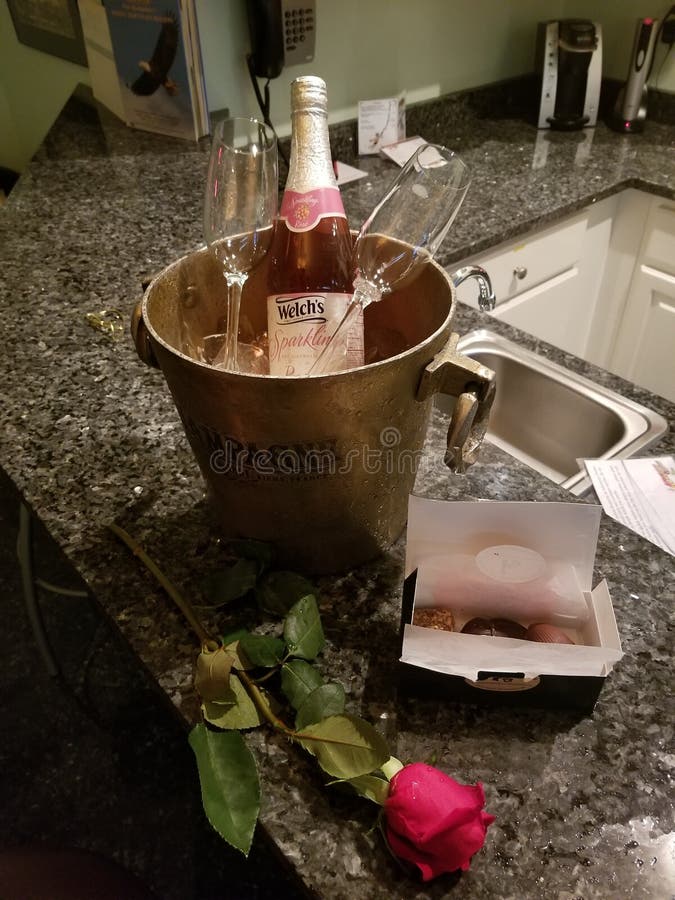 A Bottle of Sparkling Cider on Ice and a Box of Romantic Chocolate ...
