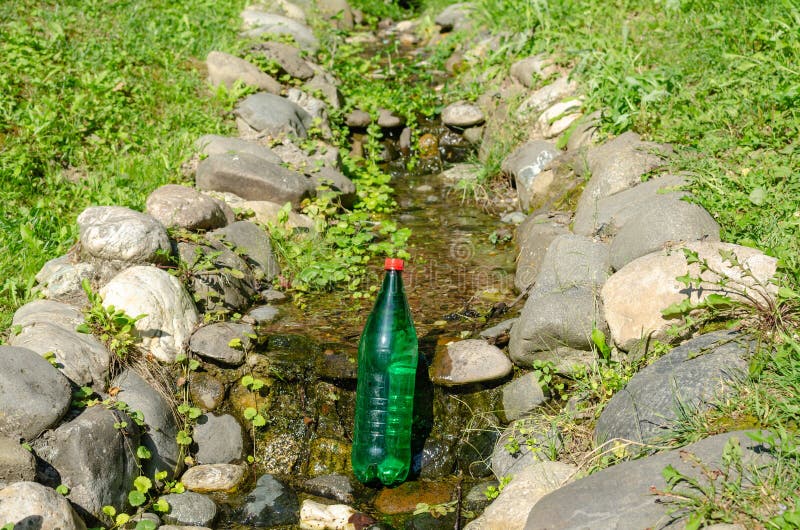 Bottle of water in a brook stock photo. Image of clean - 141846600