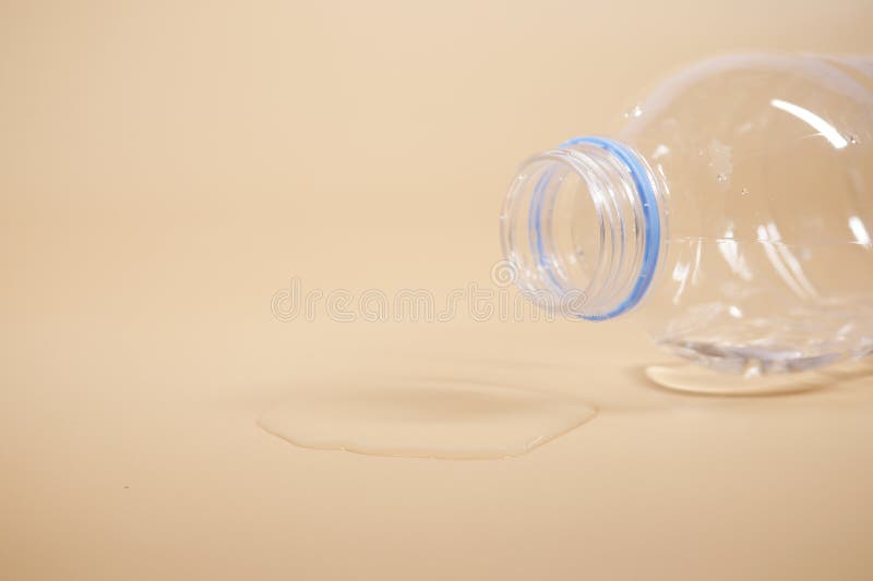 A Bottle of Water Spilled on a Table , Stock Image - Image of flowing ...