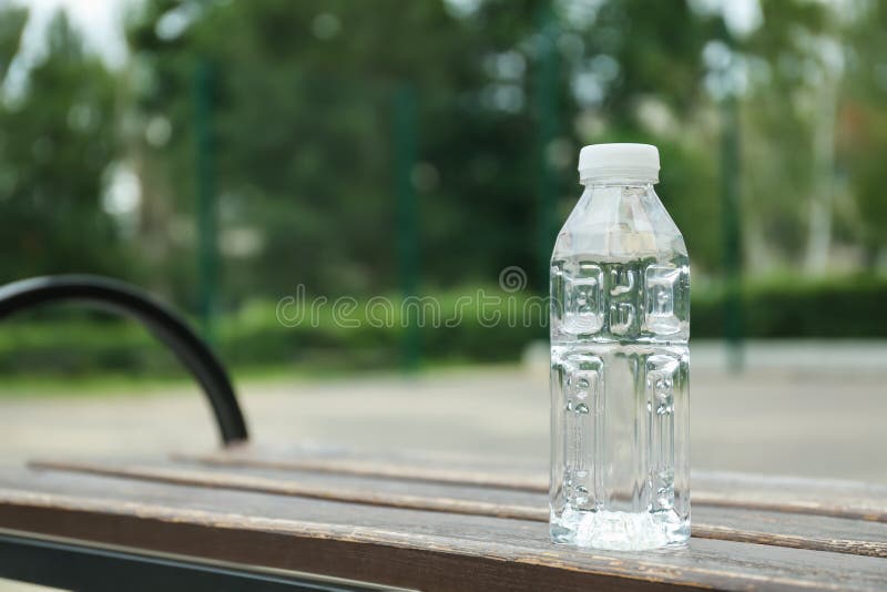 Bottle with Water on Bench Outdoors. Space for Text Stock Image - Image ...