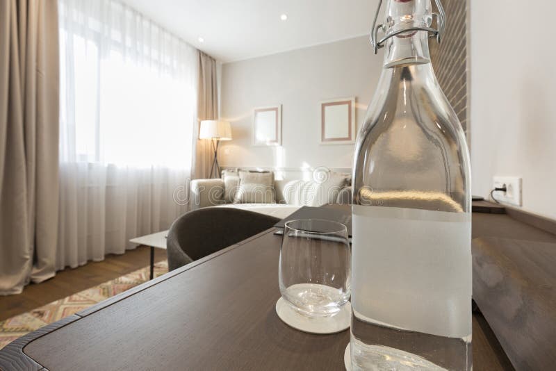 Bottle of Water on Wooden Table in Hotel Room Stock Photo - Image of ...