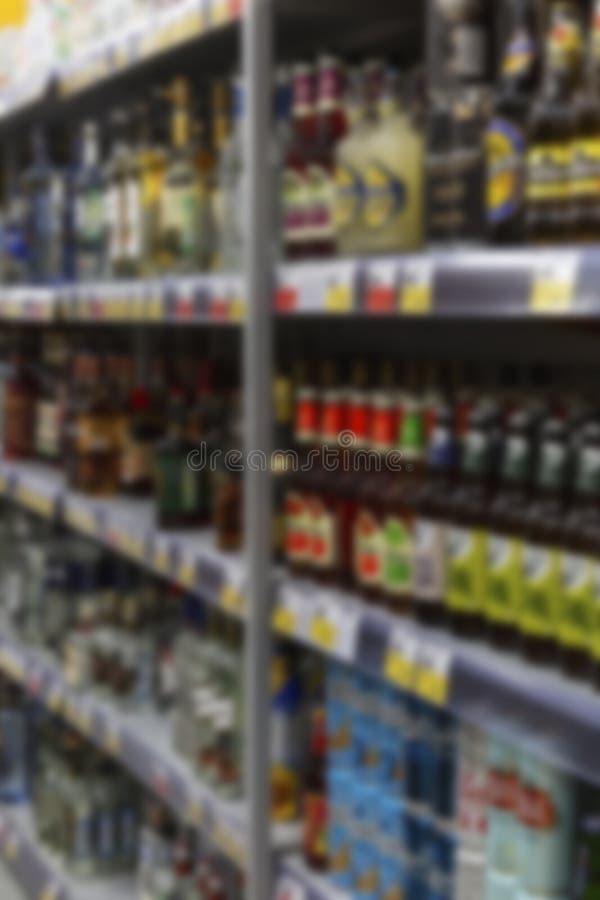 Bottled Beer on the Shelves in the Store. Side View. Blurred Stock ...