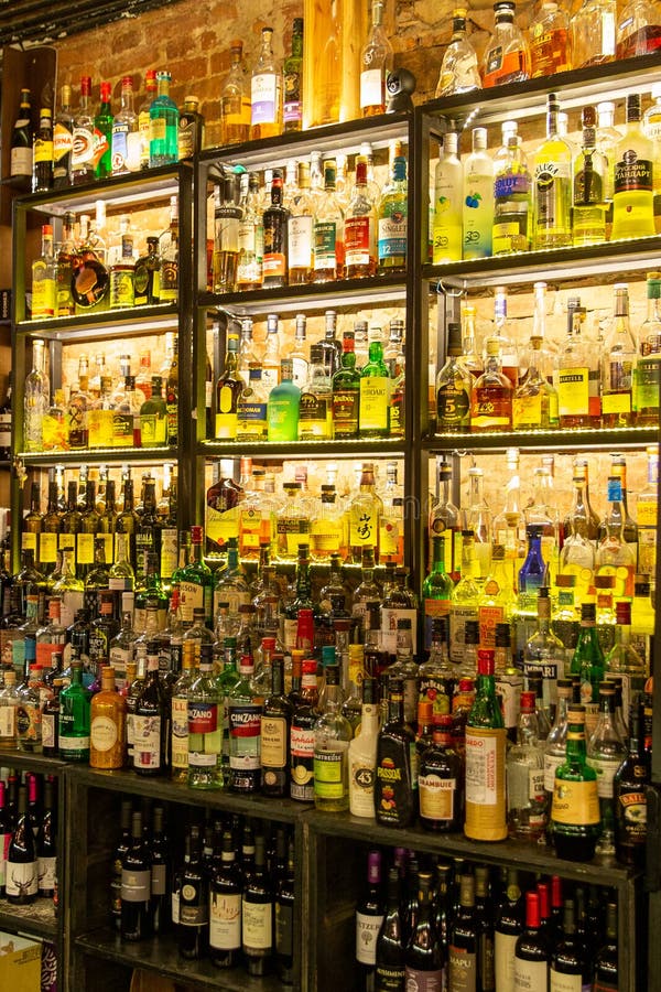 Bottles of Alcohol Behind the Bar Editorial Stock Photo - Image of ...