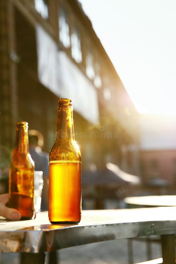 Bottles with Beer on Table Outdoors Closeup Stock Photo - Image of high ...