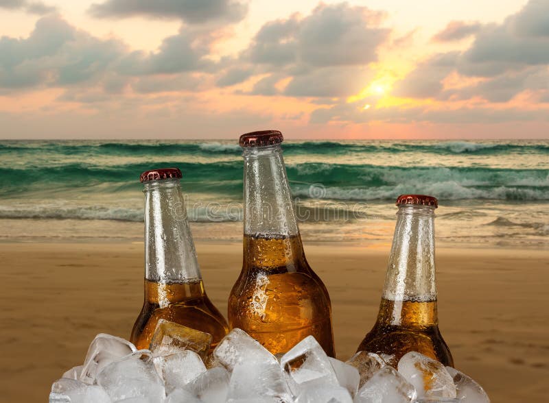 Bottles of Cold Beer in the Ice Cubes at the Sea Shore during Sunset ...