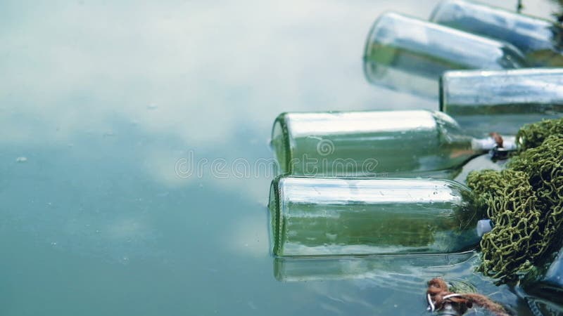 Bottles Connected with Notes Inside Float by the Lake. Quests, Games ...