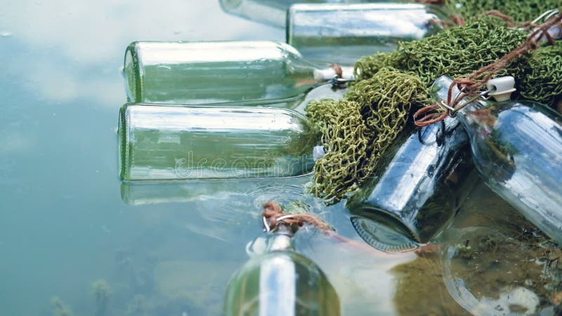 Bottles Connected with Notes Inside Float by the Lake. Quests, Games ...