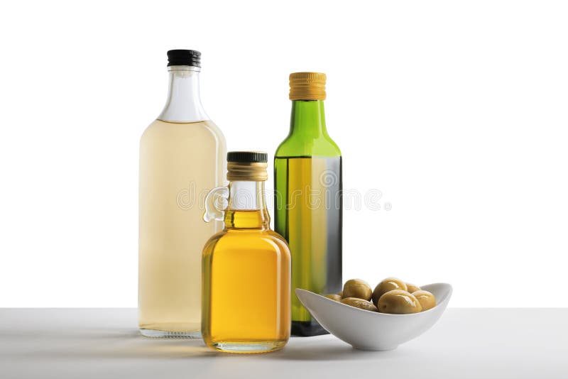Bottles of Different Cooking Oils and Olives on White Background Stock ...