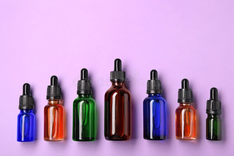 Bottles of Essential Oils on Color Background. Cosmetic Products Stock ... Bottles of Essential Oils on Color Background. Cosmetic Products Stock ...