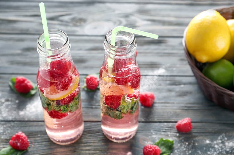 Bottles with Raspberry Oil, Fresh Berries and Raspberry Leaves O Stock ...