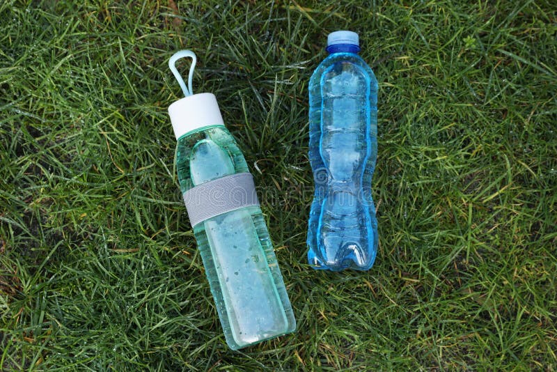 Bottles of Fresh Water on Green Grass Outdoors, Flat Lay Stock Image ...