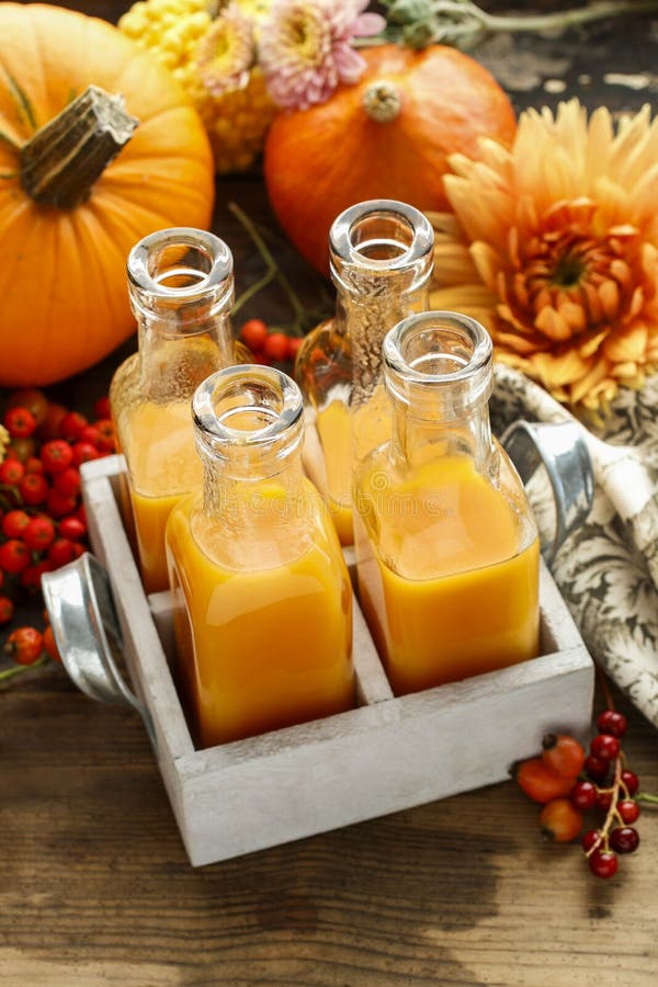 Bottles with orange juice stock image. Image of autumn - 164989425