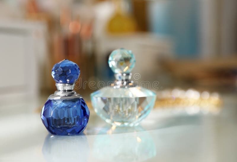 Bottles of Perfumes on Table in Stylish Room Interior Stock Photo ...