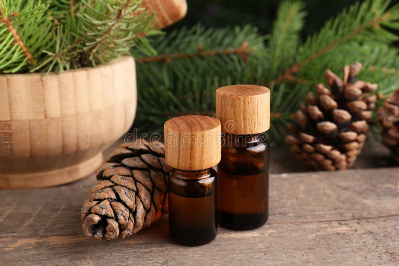 Bottles of Pine Essential Oil, Conifer Tree Branches and Cones on ...