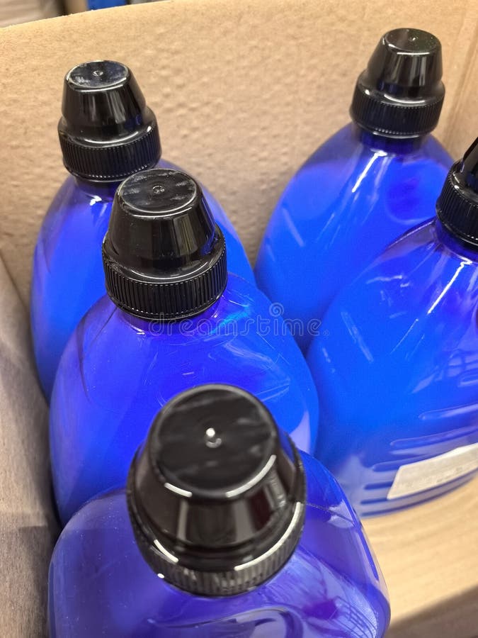 Bottles of Vibrant Blue Liquid Lined Up in a Cardboard Box Stock Photo ...