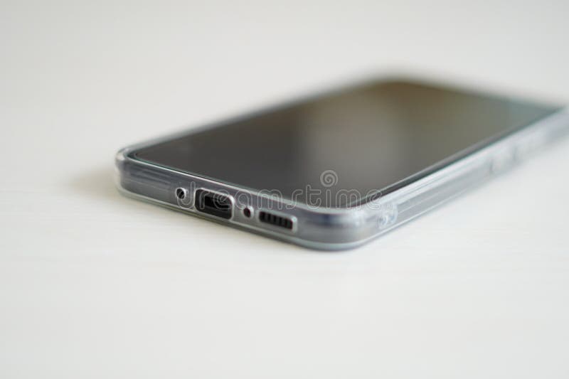 The Bottom of a Smartphone Placed on a White Table Stock Photo - Image ...