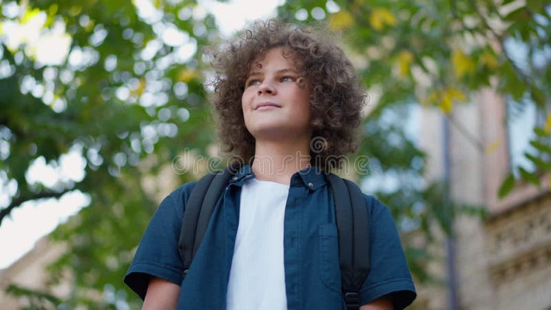 Bottom Angle View Portrait of Smiling Schoolboy Looking Away Talking in ...