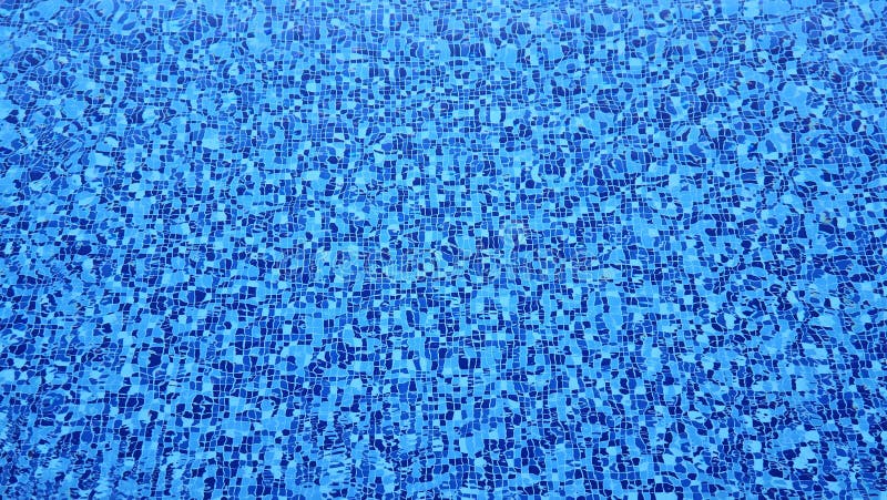 The Bottom of a Swimming Pool Made of Multi-colored Tiles Under a Layer ...