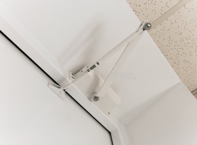 Bottom Up View of a Door Closer Installed on a Metal White Door Stock ...