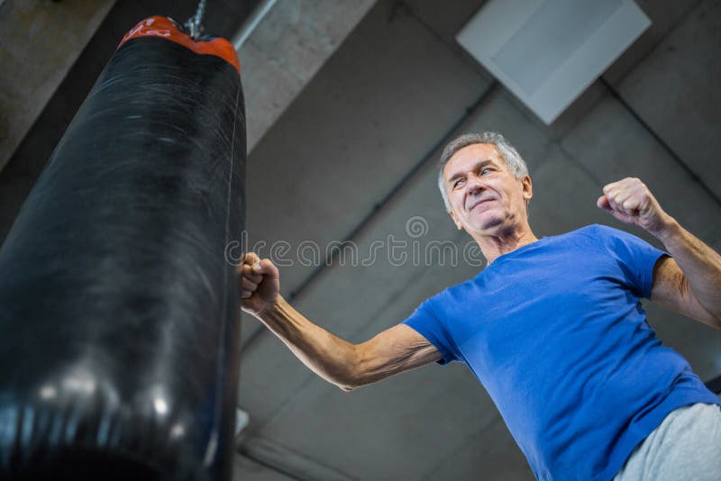 Confident Senior Man Training on Punching Bag Stock Photo - Image of ...
