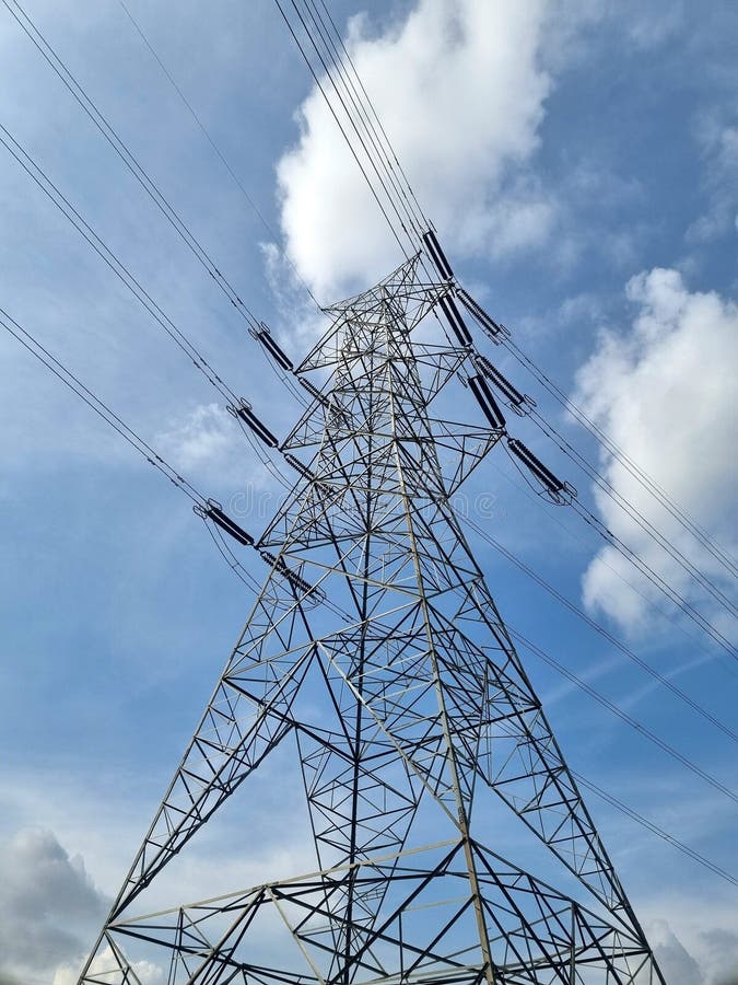 Bottom View of an Electrical Tower with Wires and Clouds in the ...