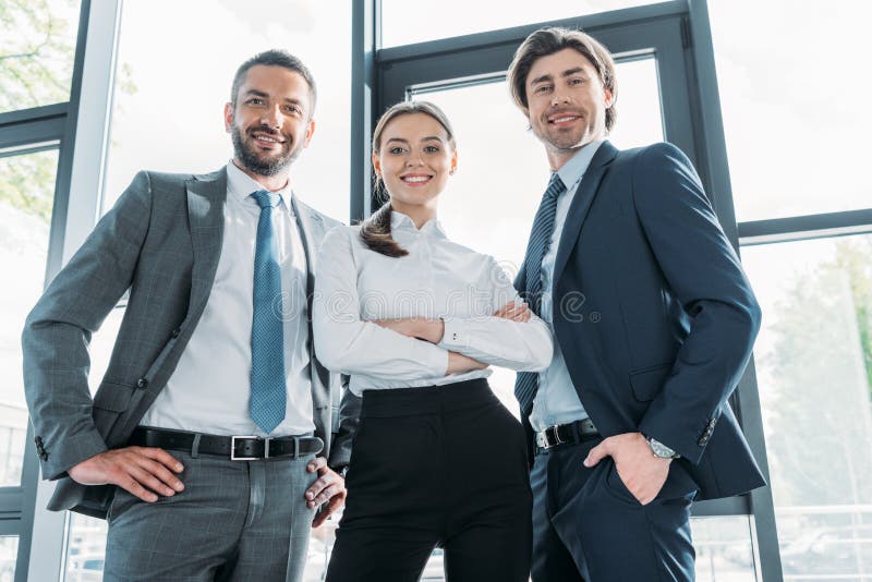 Bottom View of Group of Smiling Young Business People Standing at ...