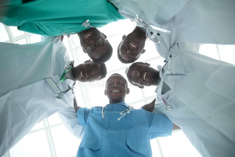 Bottom View. Group of Young Doctors Standing in a Circle Stock Photo ... Bottom View. Group of Young Doctors Standing in a Circle Stock Photo ...