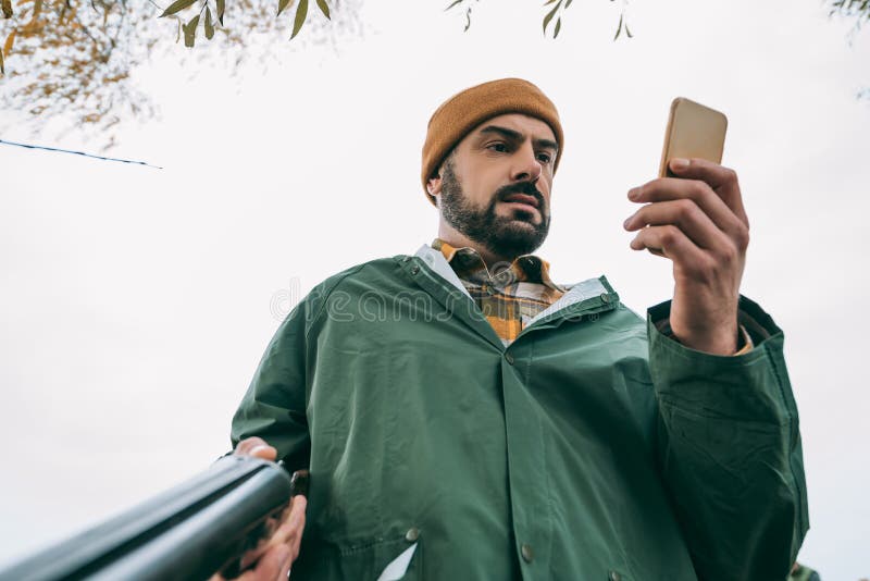 Bottom View of Handsome Hunter Standing with a Gun and Looking Stock ...