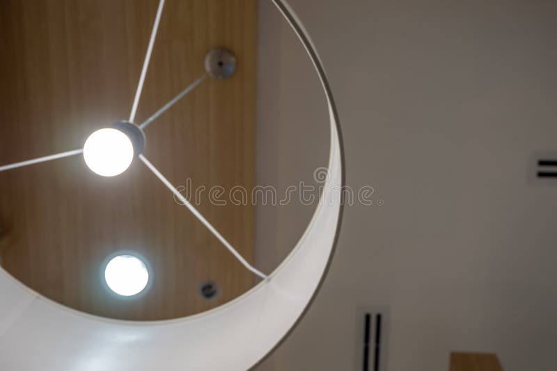 Bottom View of Light Bulb in Lamp Hanging from Ceiling on Blurred ...