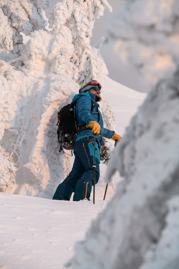 Bottom View of Man in Ski Suit and with Trekking Poles among Snow ...