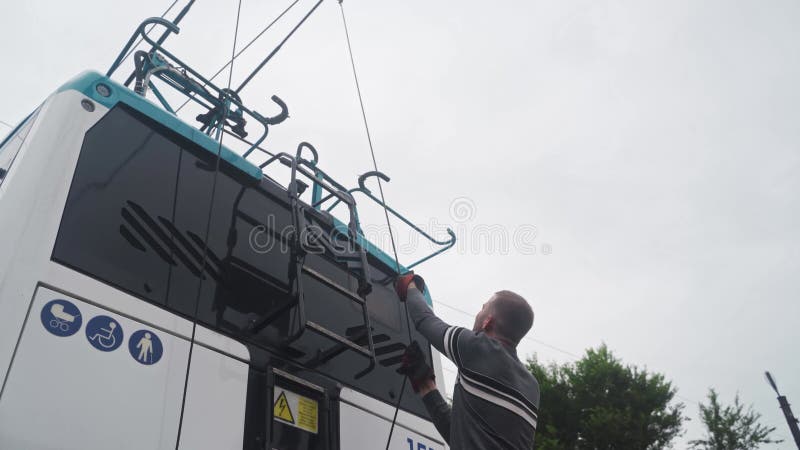 Overhead View of Professional Driver Stands at Back Side of Trolleybus ...