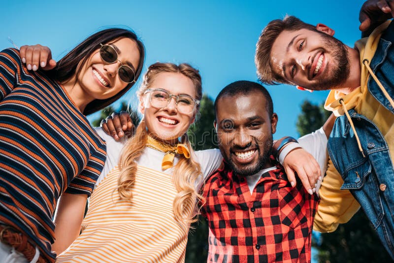 Bottom View of Smiling Multiracial Young Friends Looking at Camera with ...