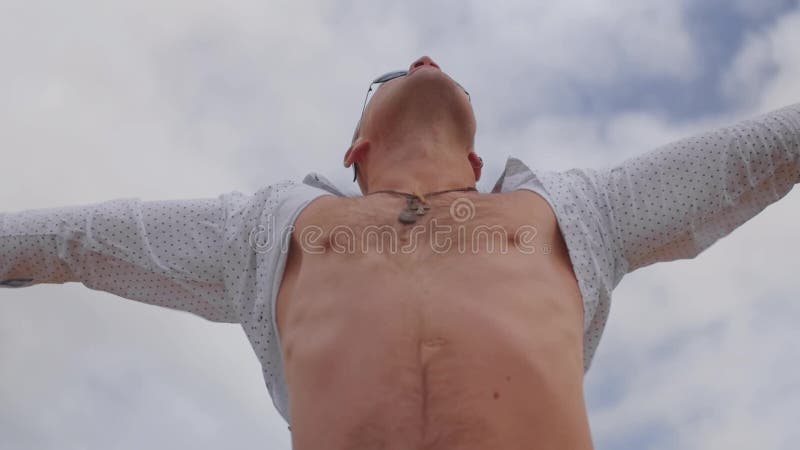 Bottom View of a Standing Man and Spreading His Arms Against the ...