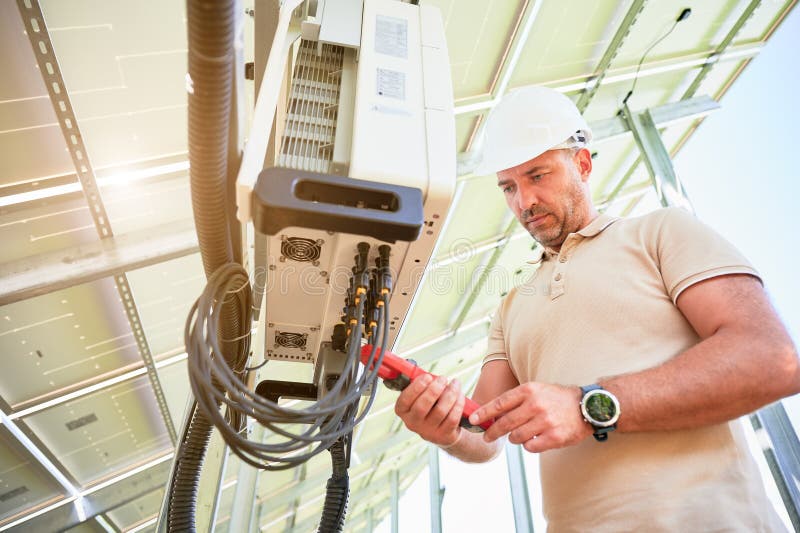 Bottom View of Worker Checking Solar Inverter Work. Stock Image - Image ...