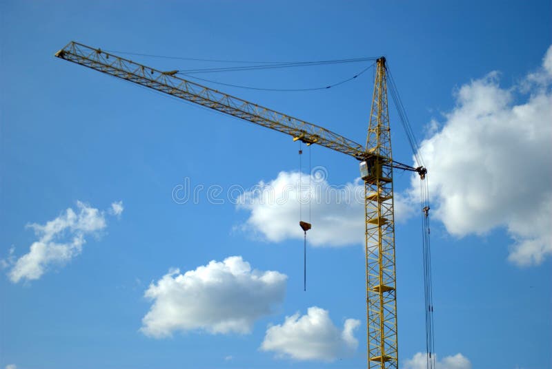 Bottom View of a Tower Crane and a High-rise Apartment Building Under ...